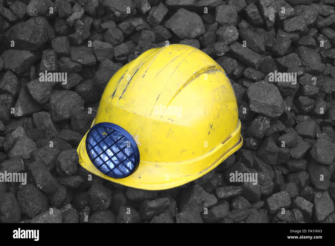 Helmet on top of the coal mining Stock Photo - Alamy