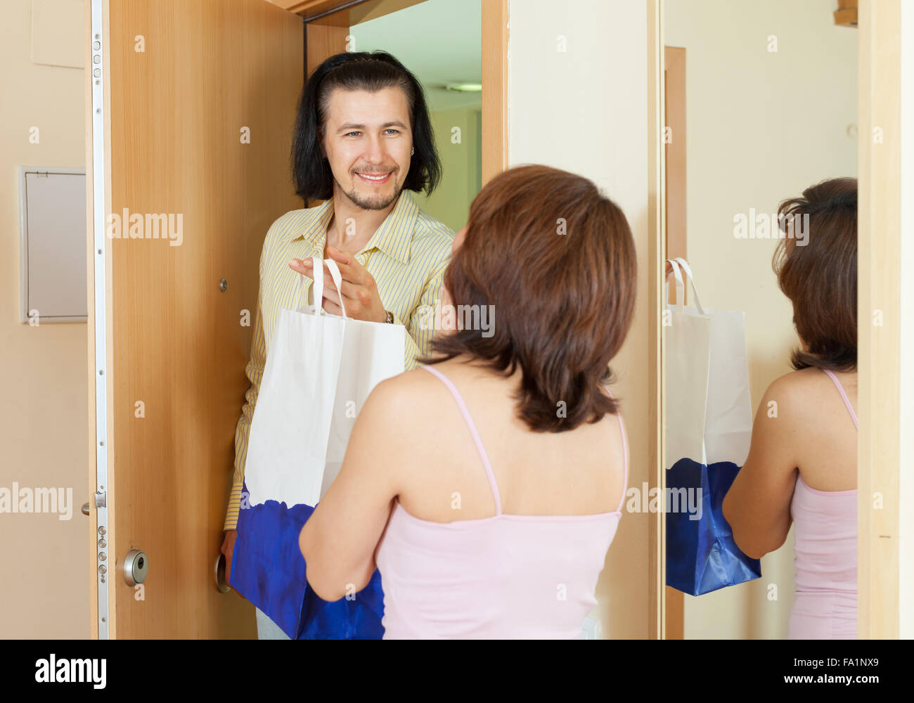 A generous man came to the woman with a gift at home Stock Photo - Alamy
