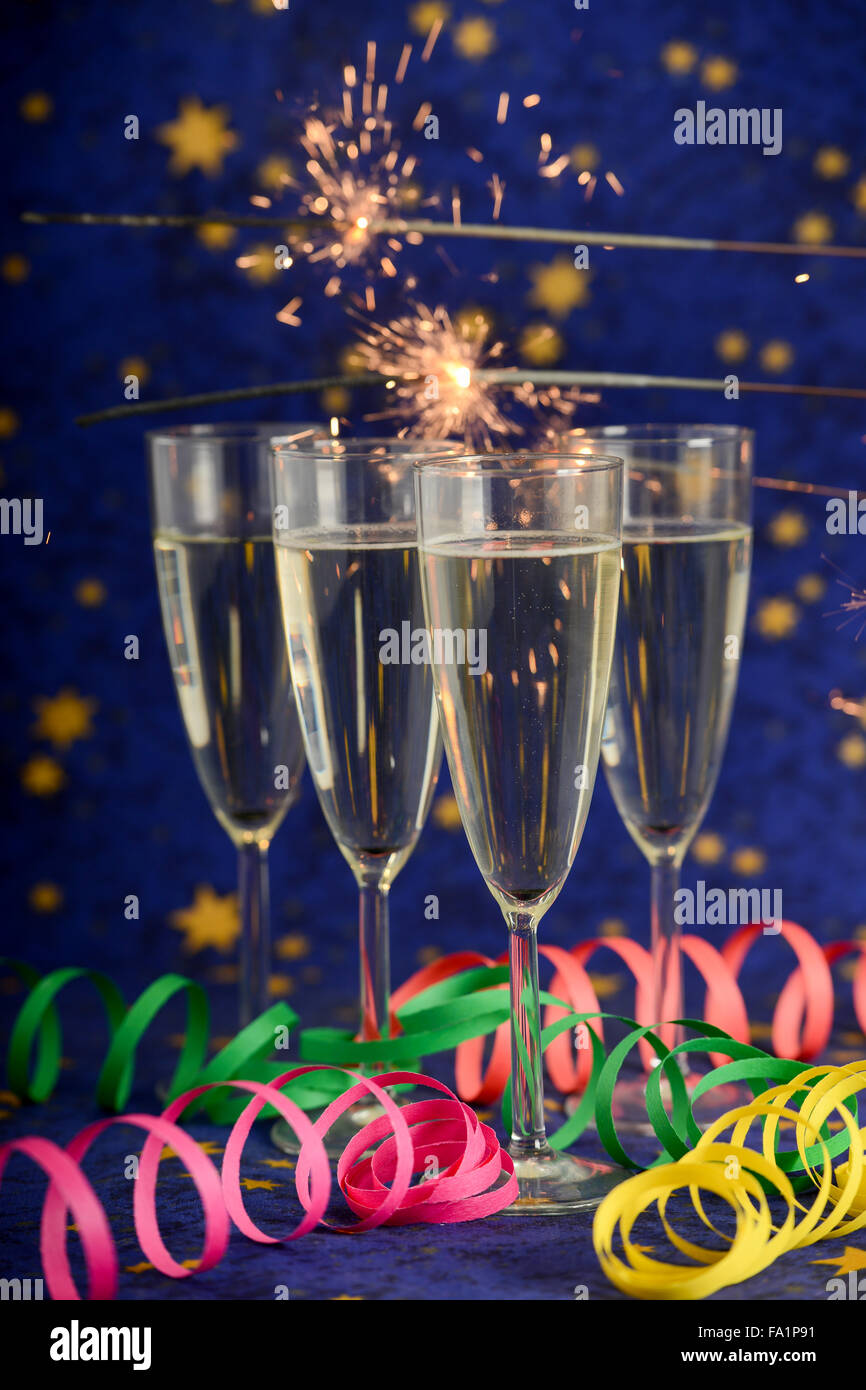 New Year celebration. Glasses with champagne against holiday lights ...