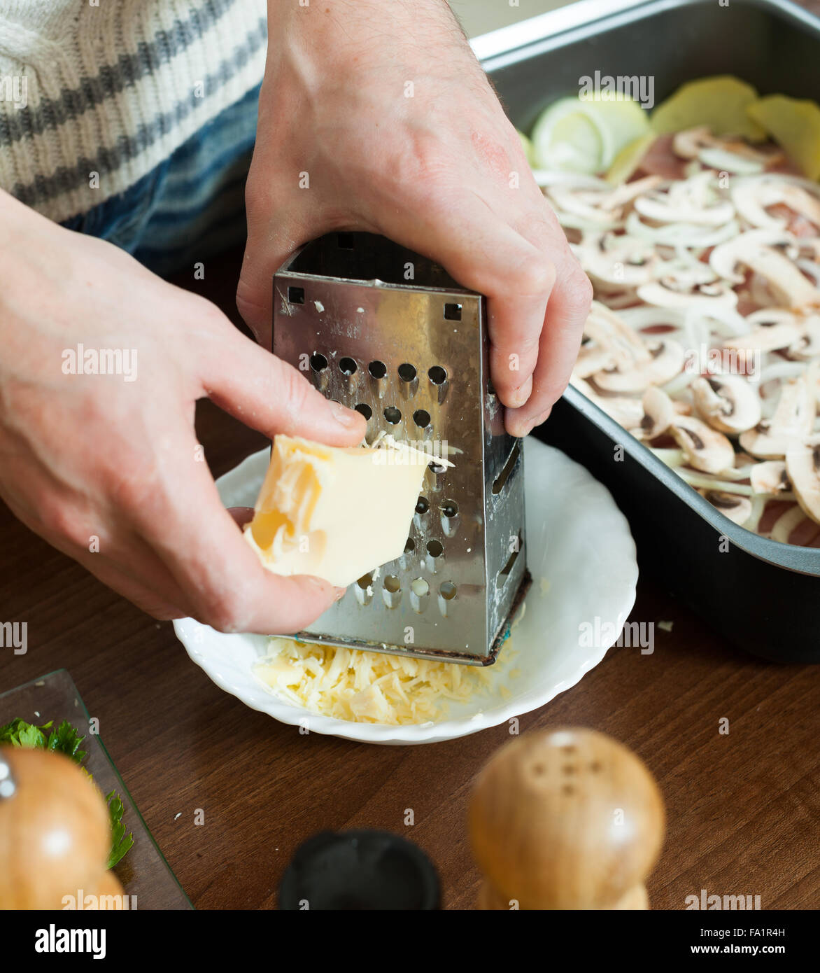 Closeup of Cooking French-style meat - freating cheese on grater Stock ...