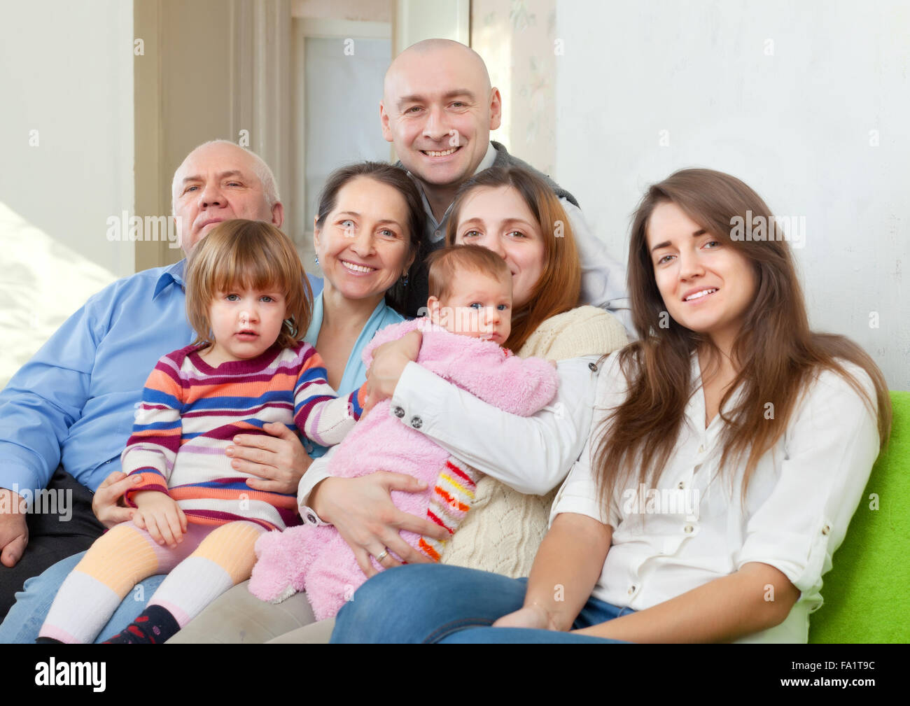 Happy three generations family sits on sofa in home interior Stock ...