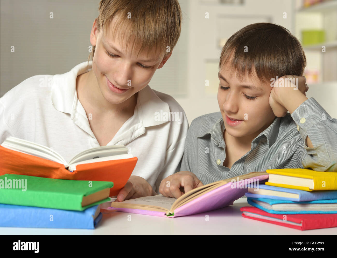 Two brothers doing homework at home Stock Photo - Alamy