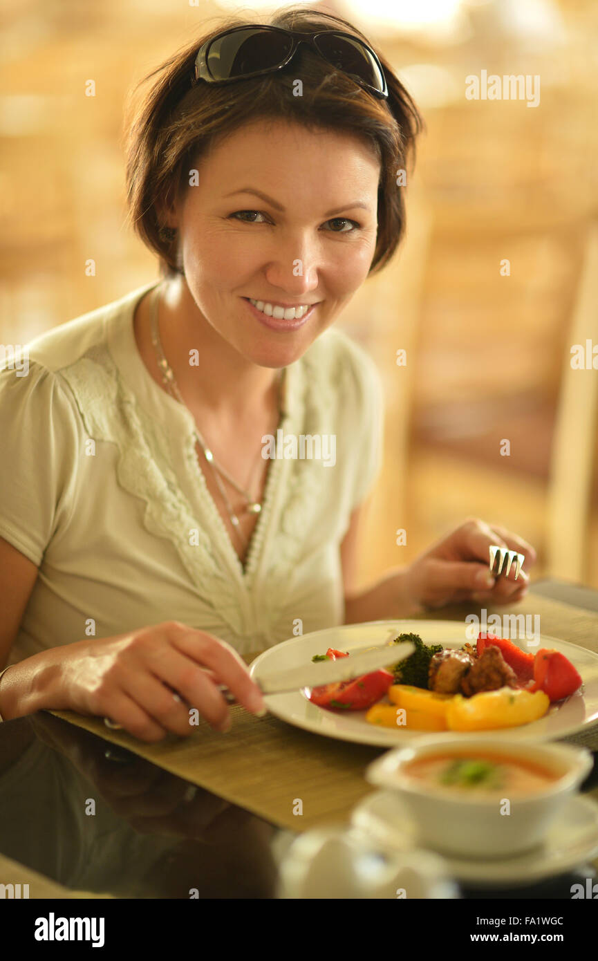 Woman eating at cafe Stock Photo - Alamy