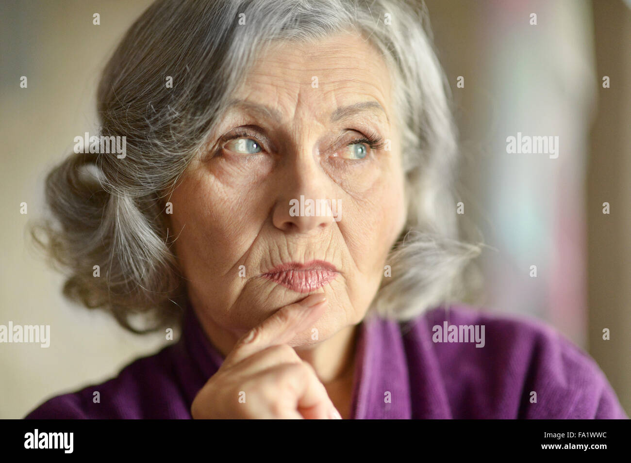 Portrait of thinking elderly woman Stock Photo - Alamy