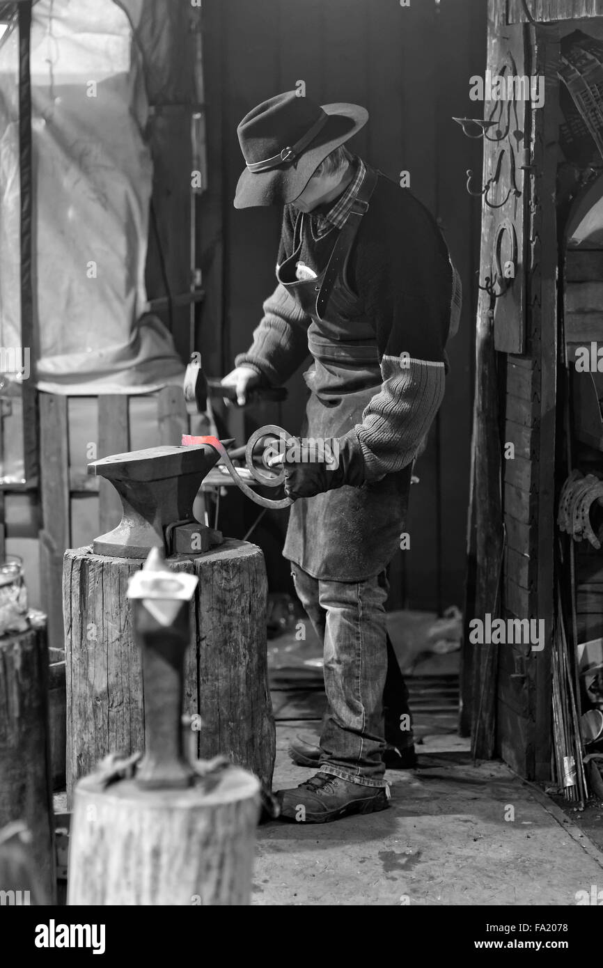 A blacksmith at work in the Christmas Market in Krakow; Poland Stock ...