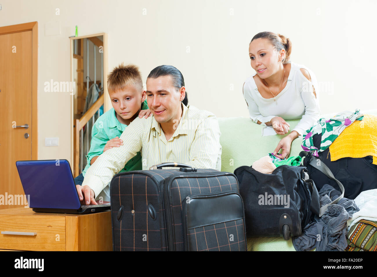 Ordinary family of three with teenager reserving tickets for vacation ...