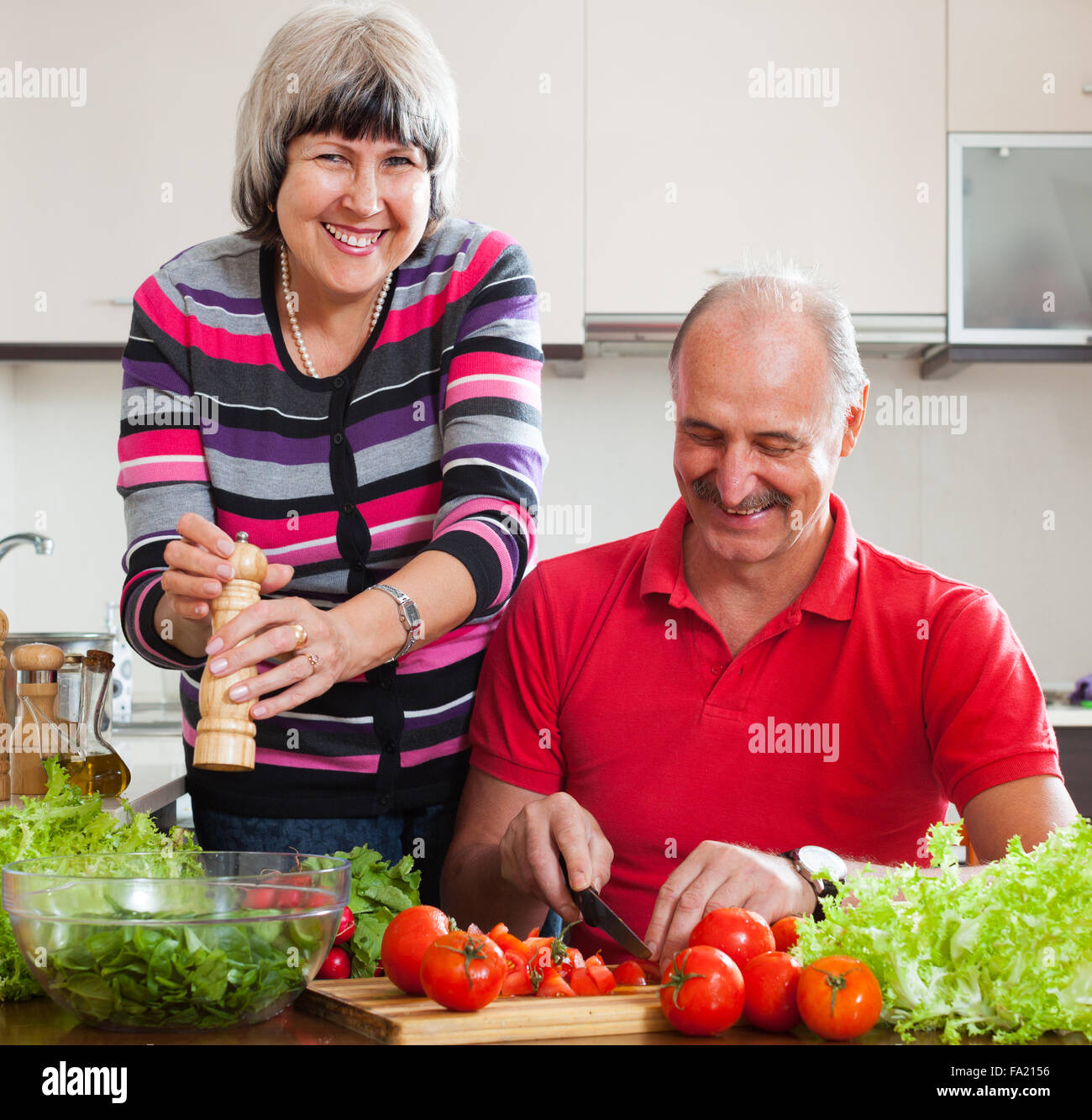 Woman mature kitchen many vegetables hi-res stock photography and ...