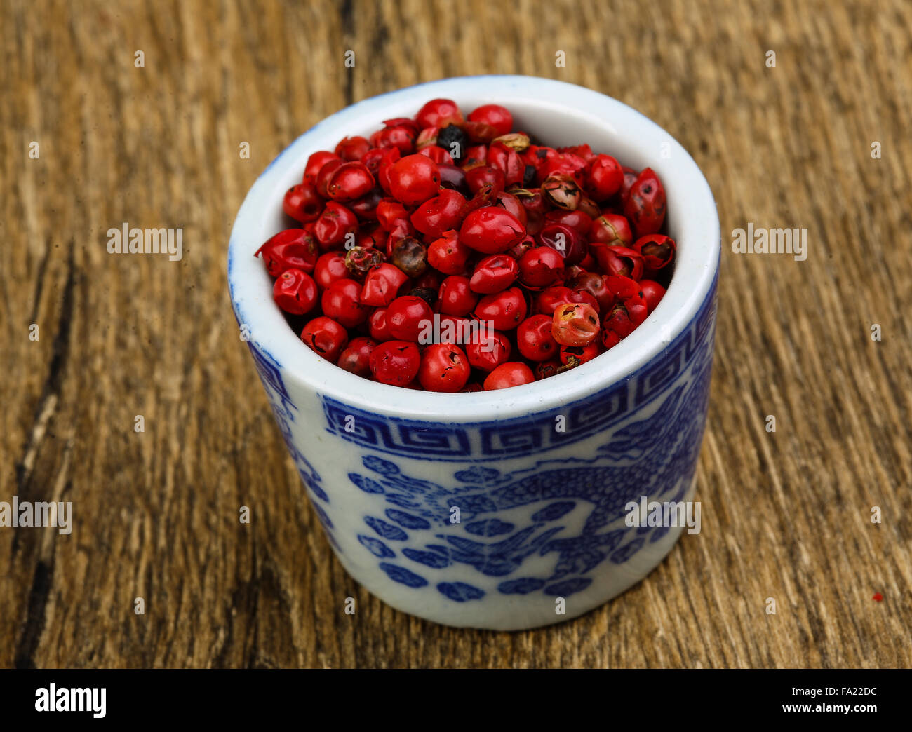 Dry Rose pepper corn on the wood background Stock Photo - Alamy