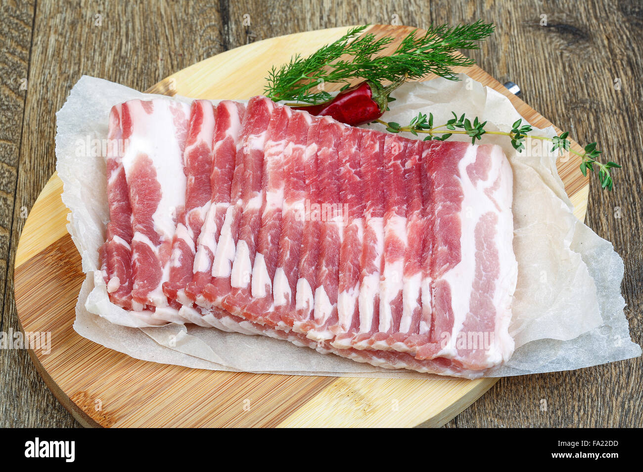 Raw sliced bacon ready for cooking on wood background Stock Photo - Alamy