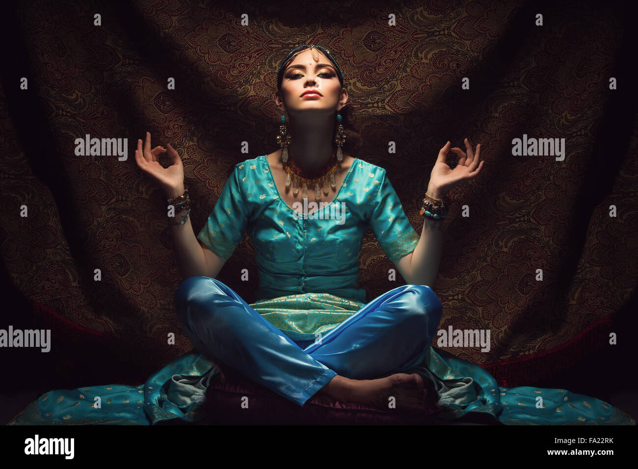 Girl sitting in lotus position Stock Photo - Alamy