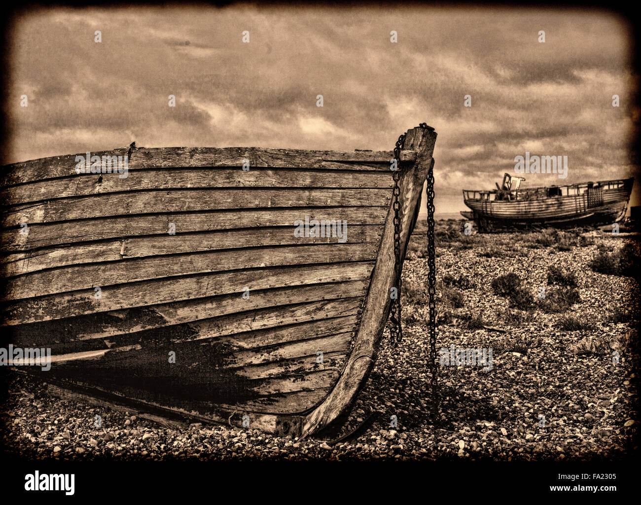 Old wooden fishing boat on a pebble beach Stock Photo - Alamy