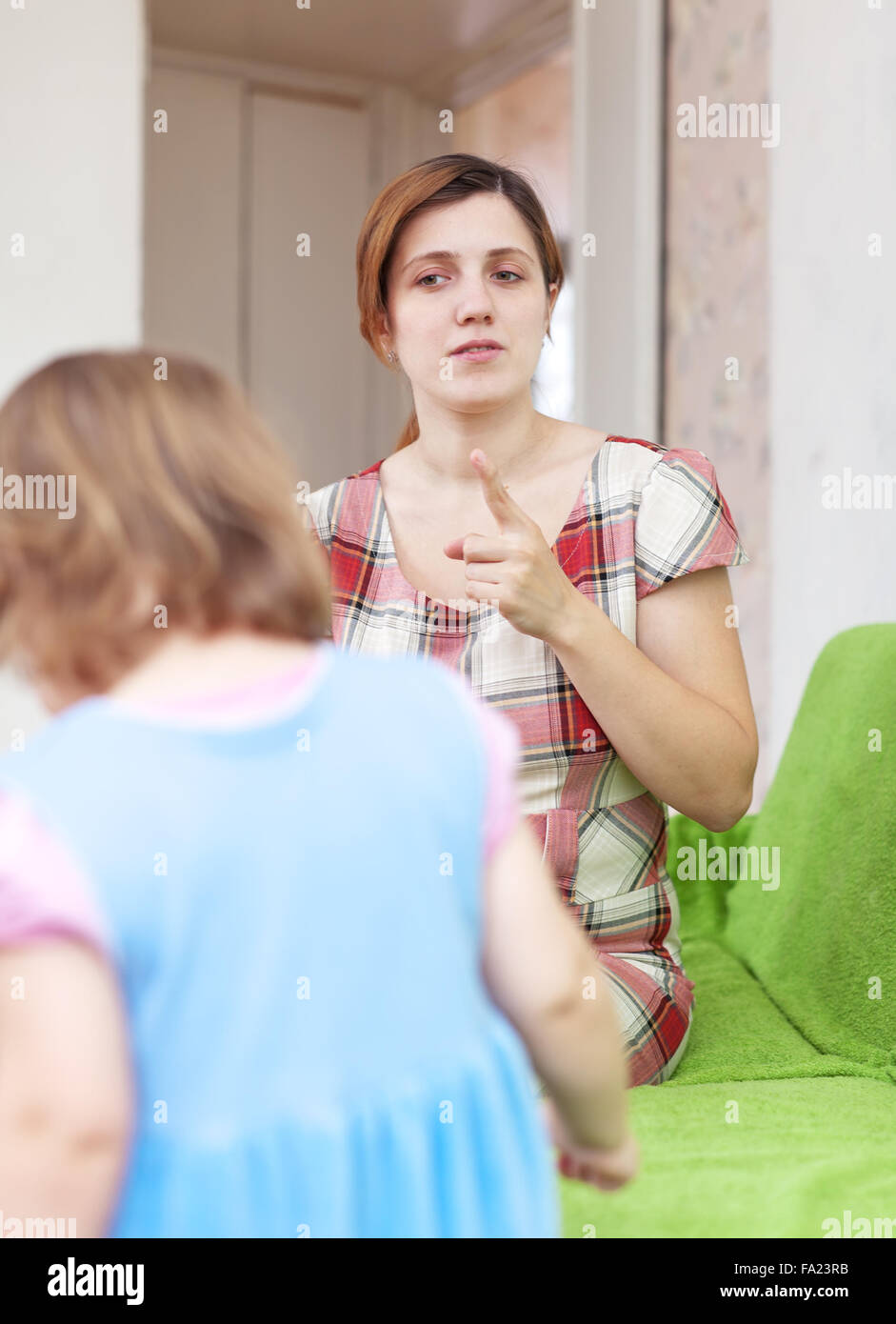 Mother scolds her child in home interior Stock Photo - Alamy