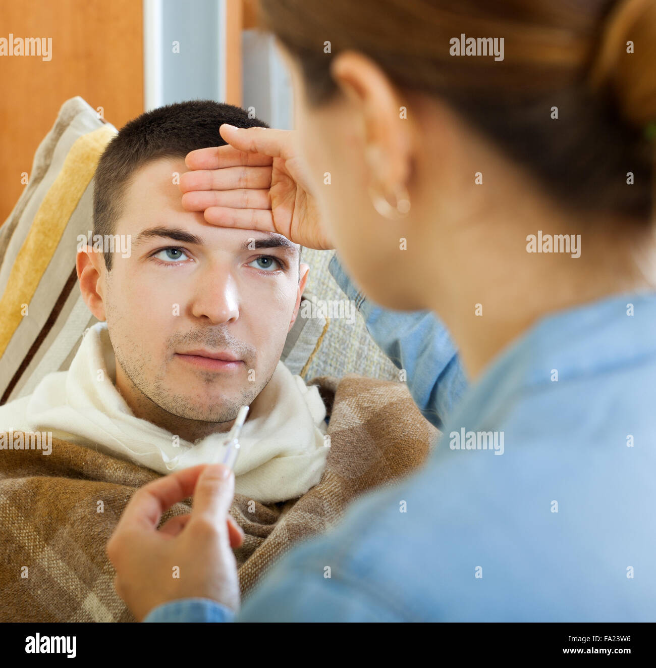Adult girl caring for sick man at home Stock Photo - Alamy
