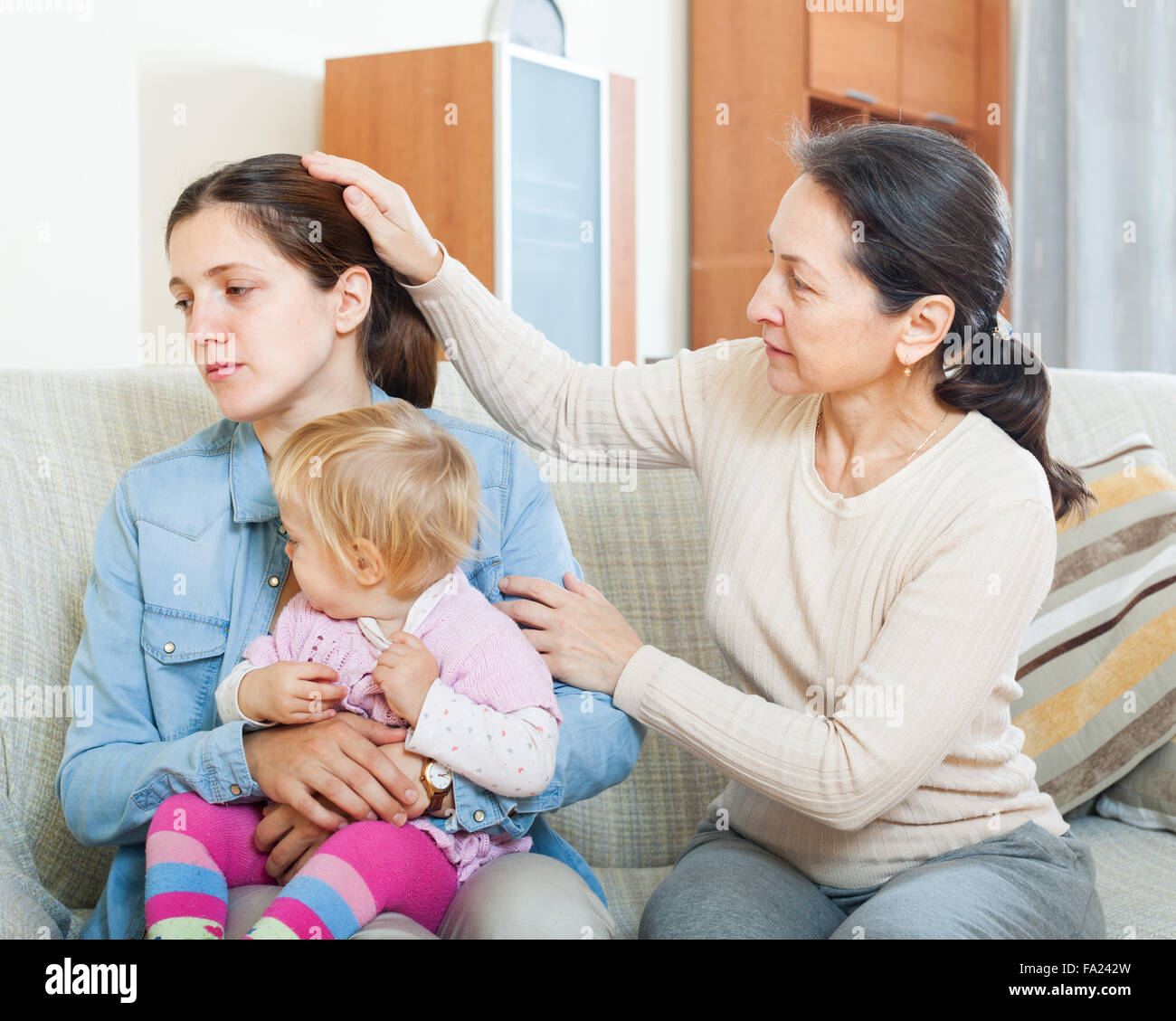 Mature woman comforting crying daughter hi-res stock photography and images - Alamy
