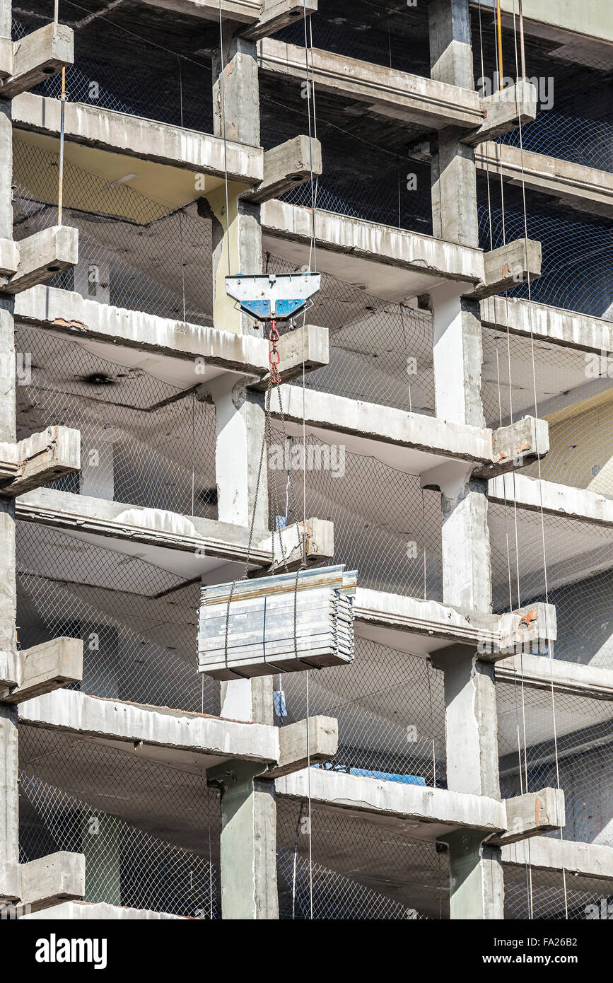 Crane lifting a lot of boards for building a skyscraper in Barcelona ...