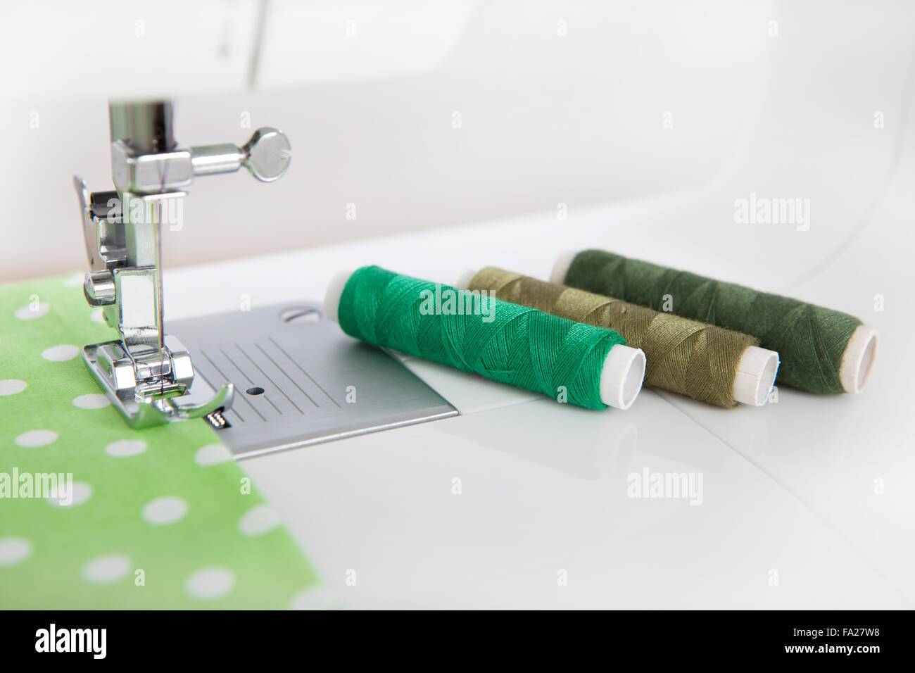 a cloth is sewn with a sewing machine, yarn of different colors Stock ...
