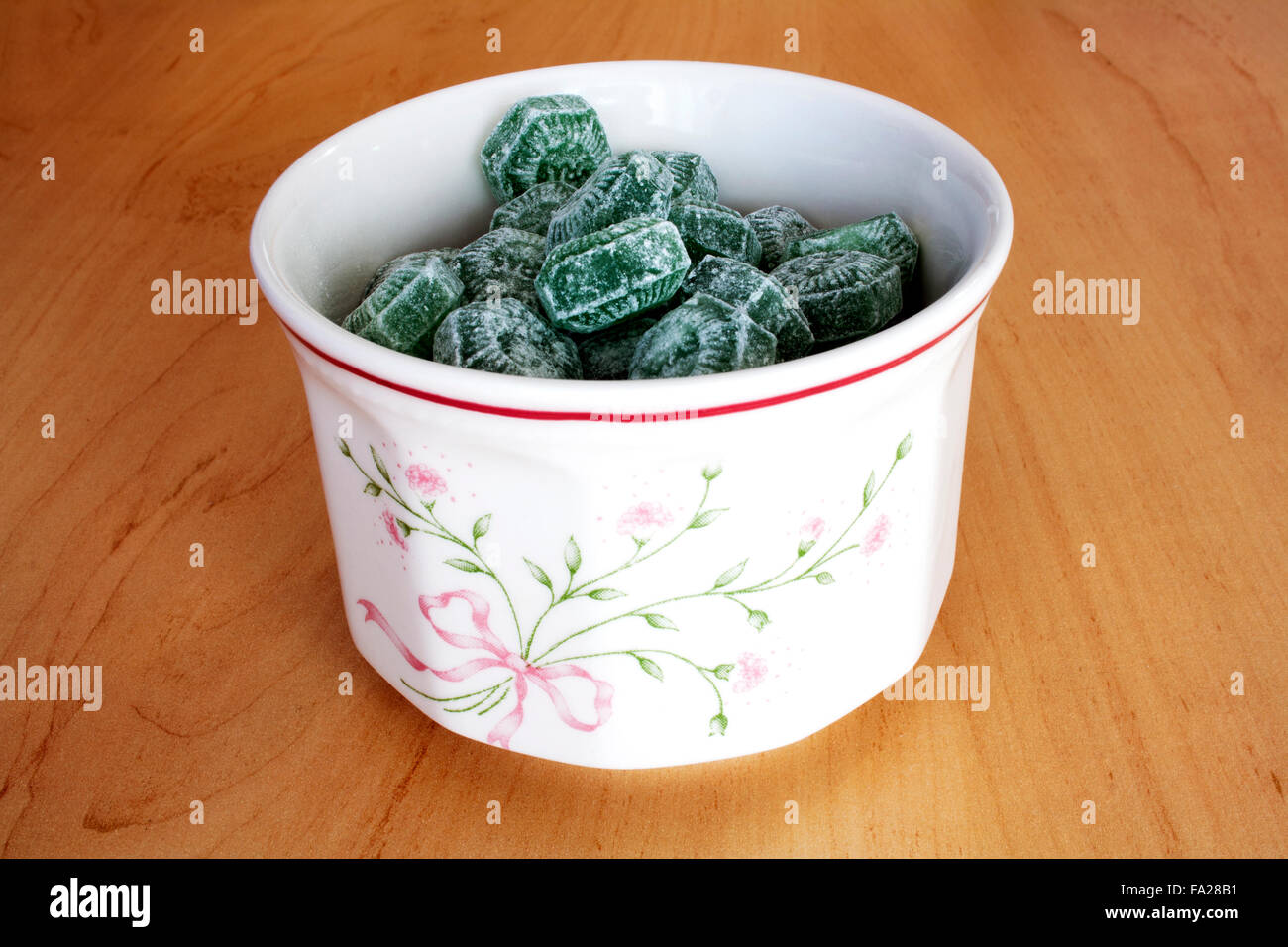 Green mint drops in a white cup Stock Photo - Alamy
