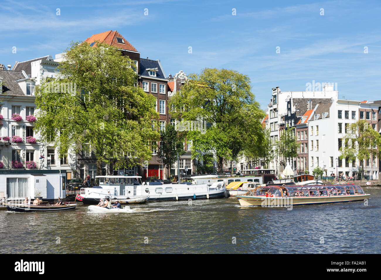 AMSTERDAM, THE NETHERLANDS - AUG 06: Canal with recreating people in ...