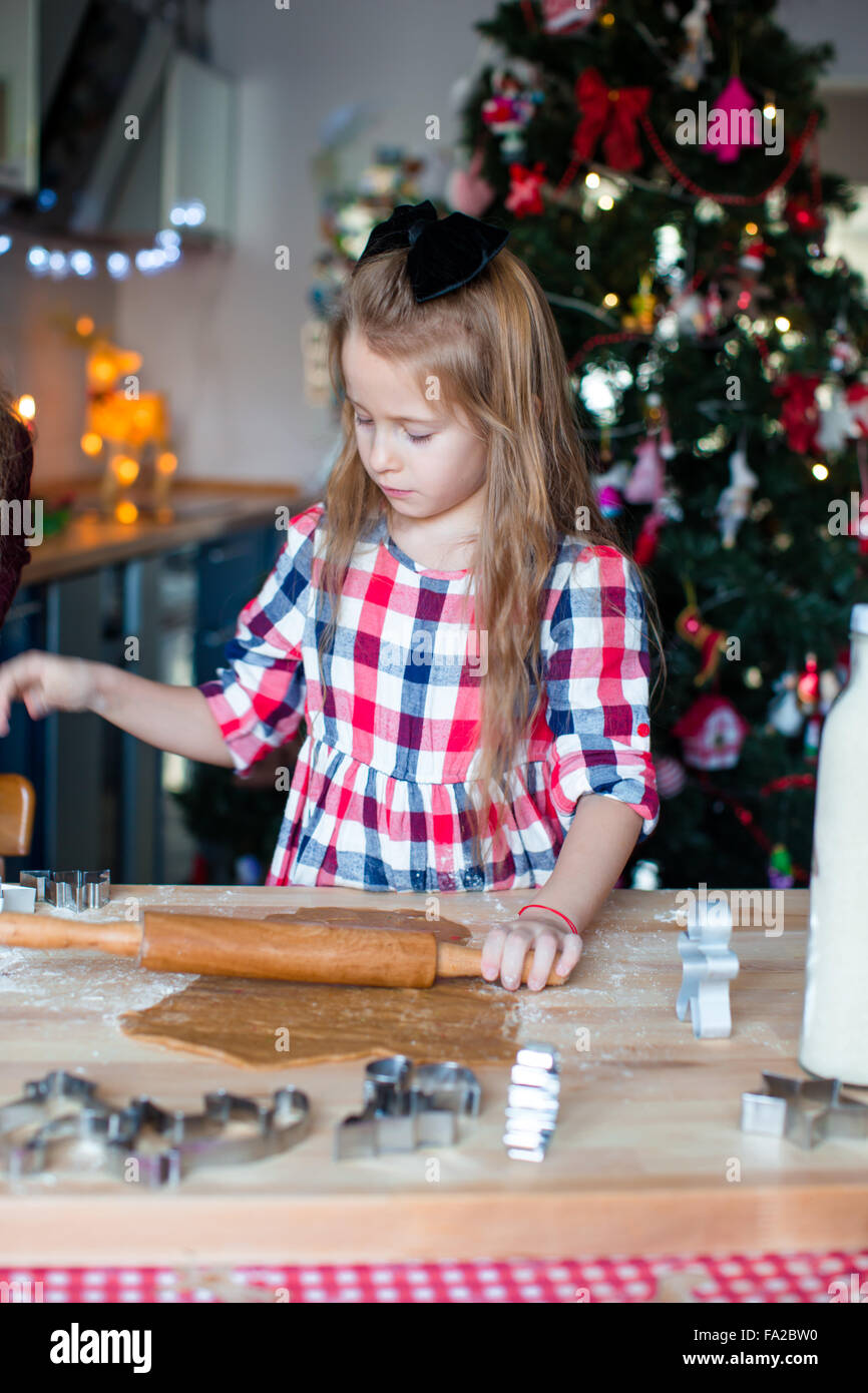 Little adorable girl baking Christmas cookies at home Stock Photo - Alamy