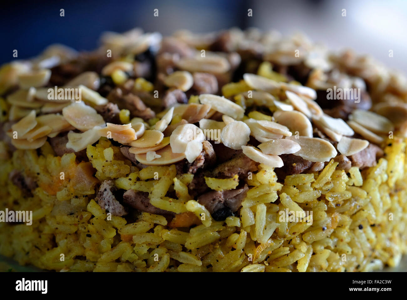 Traditional Maqluba served with crushed almonds. Maqluba or Maklube is ...