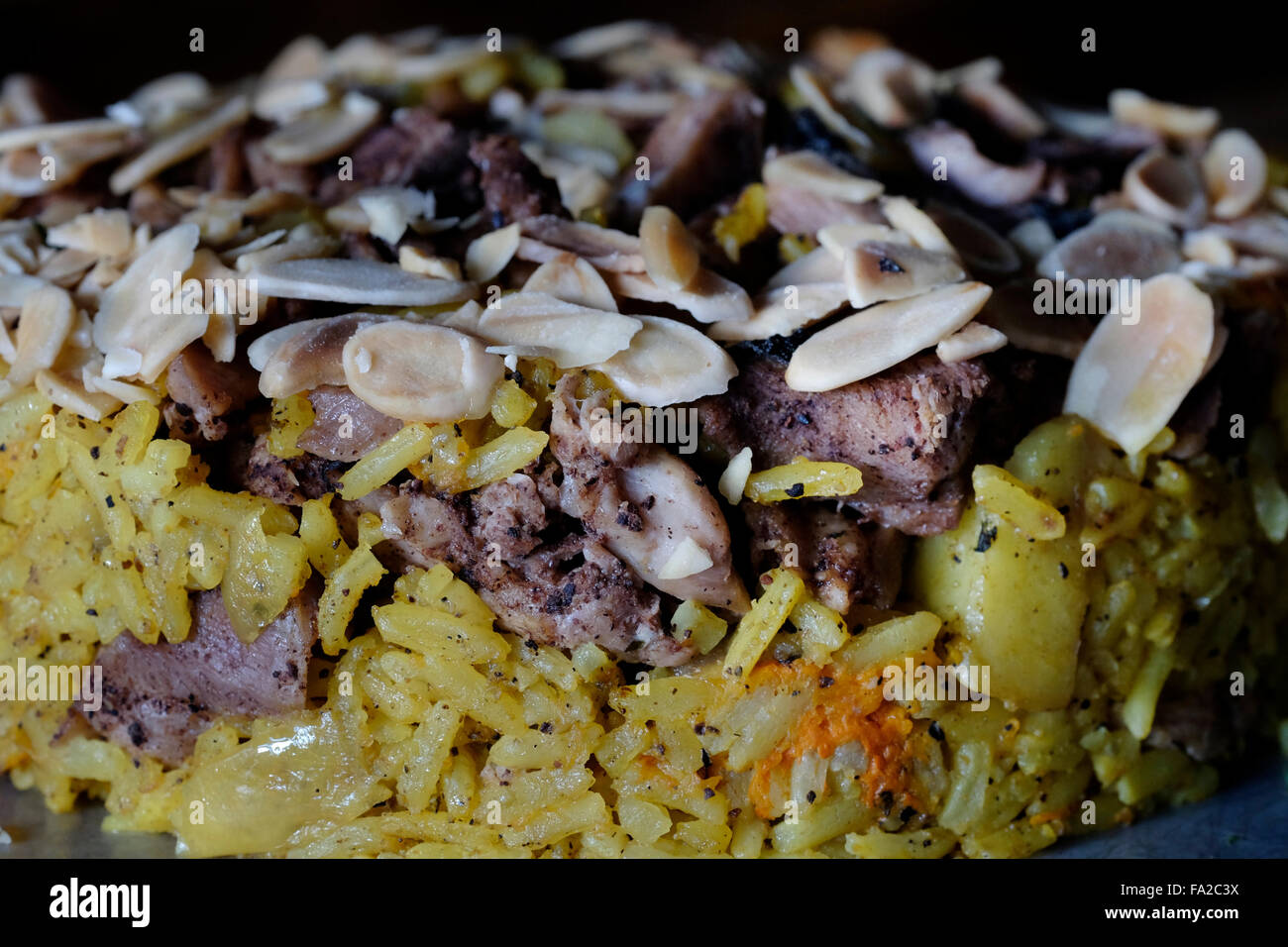 Traditional Maqluba served with crushed almonds. Maqluba or Maklube is ...