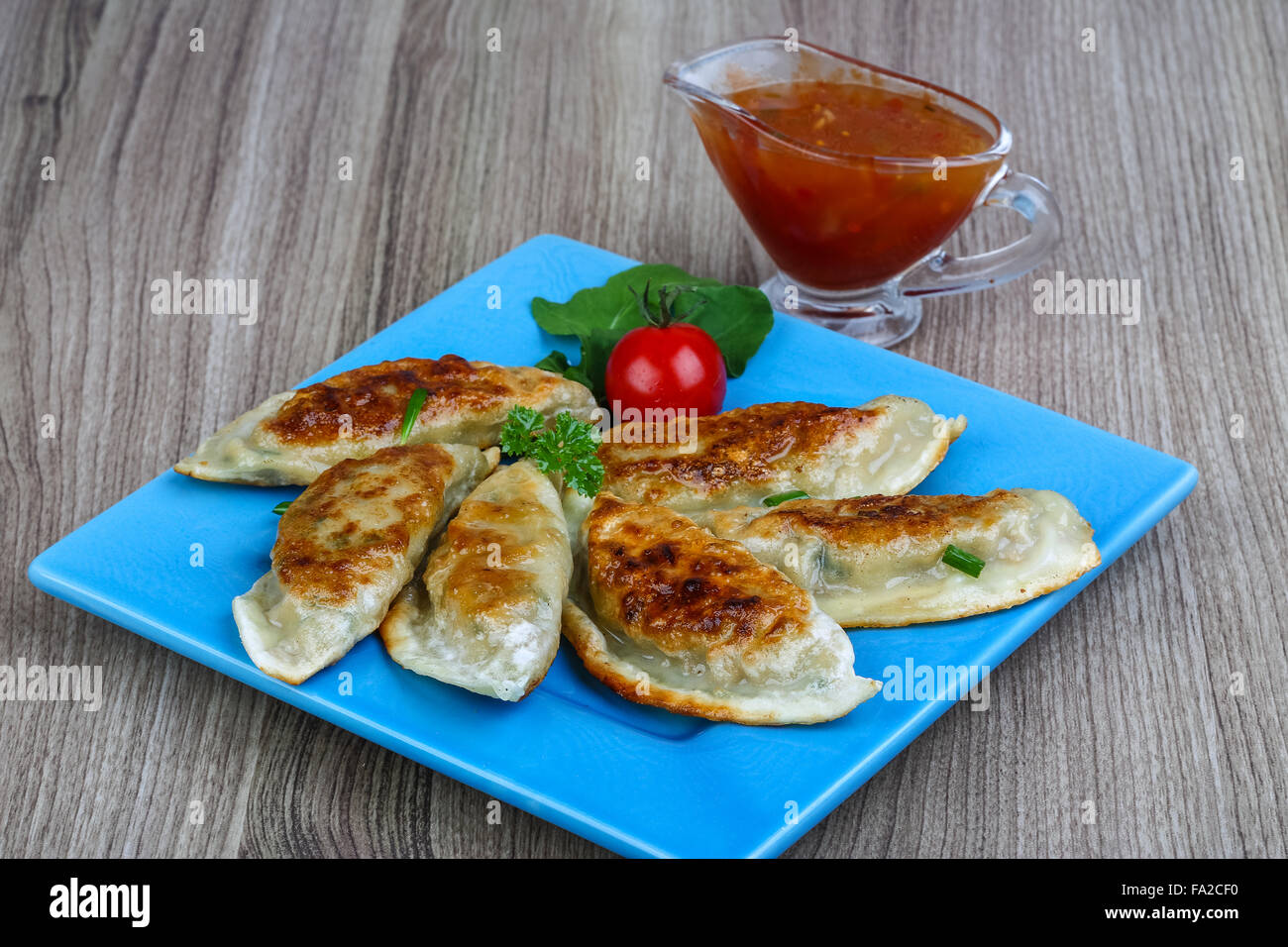 Japanese cousine - Gyoza dumplings served green onion and cherry tomato ...