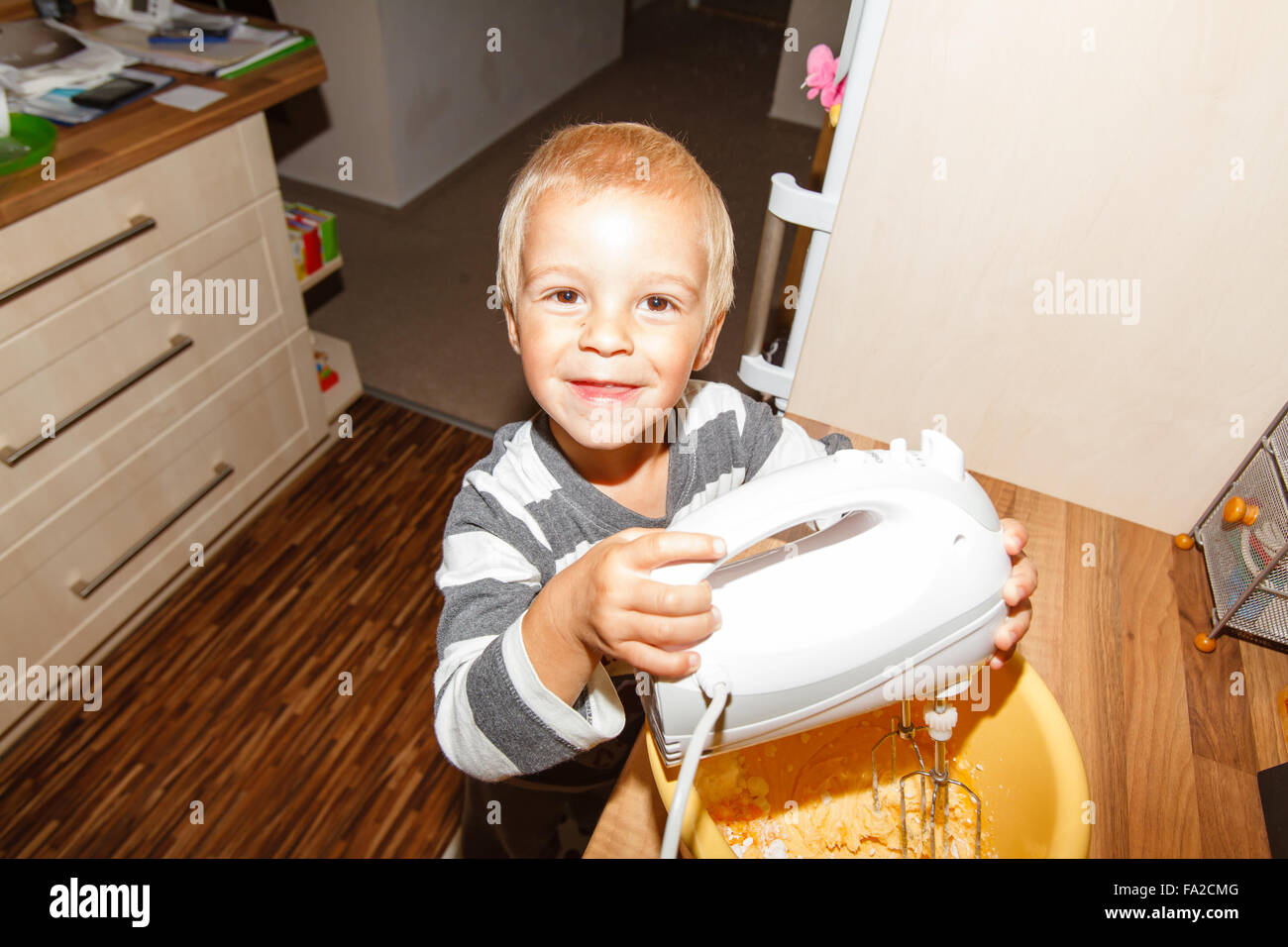 Little boy helping in the kitchen while cooking Stock Photo - Alamy