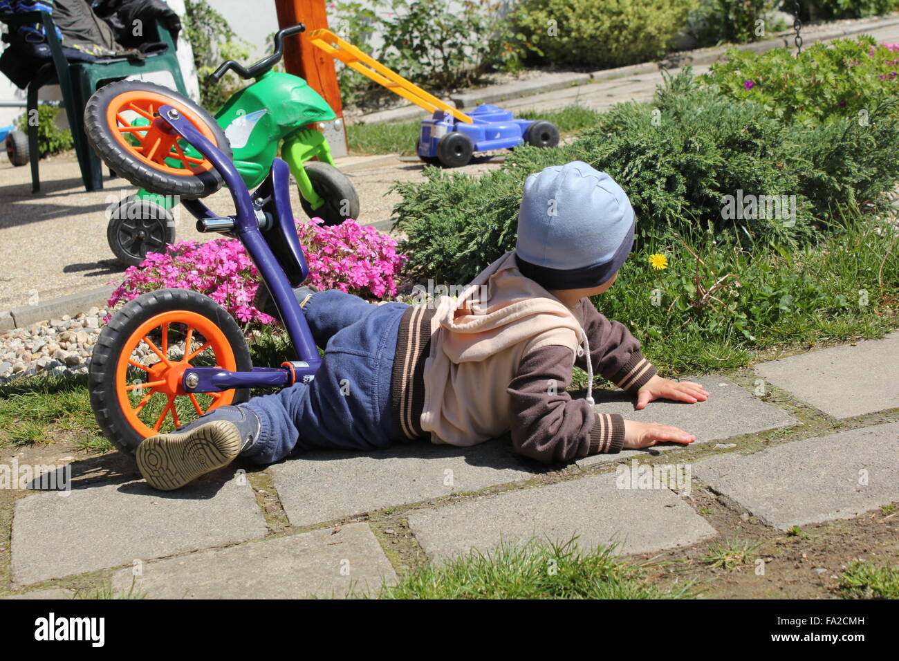 The little boy fell off the bike at first individual driving Stock ...