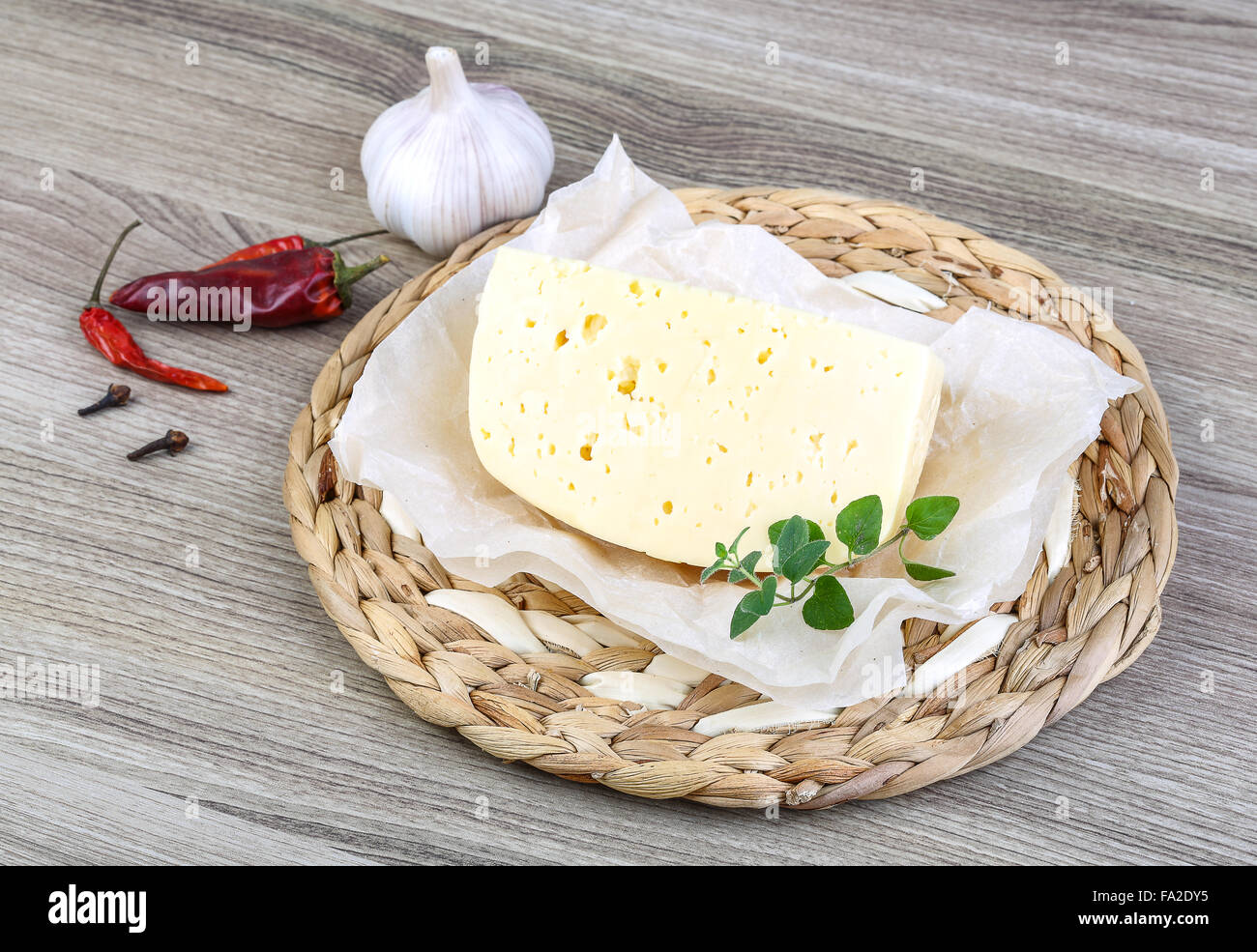 Part of round cheese on the wood background with herbs Stock Photo - Alamy