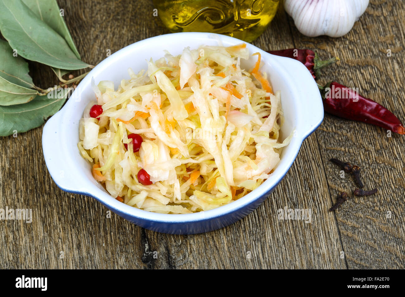 Fermented cabbage - Sauerkraut with herbs and spices on the wood ...