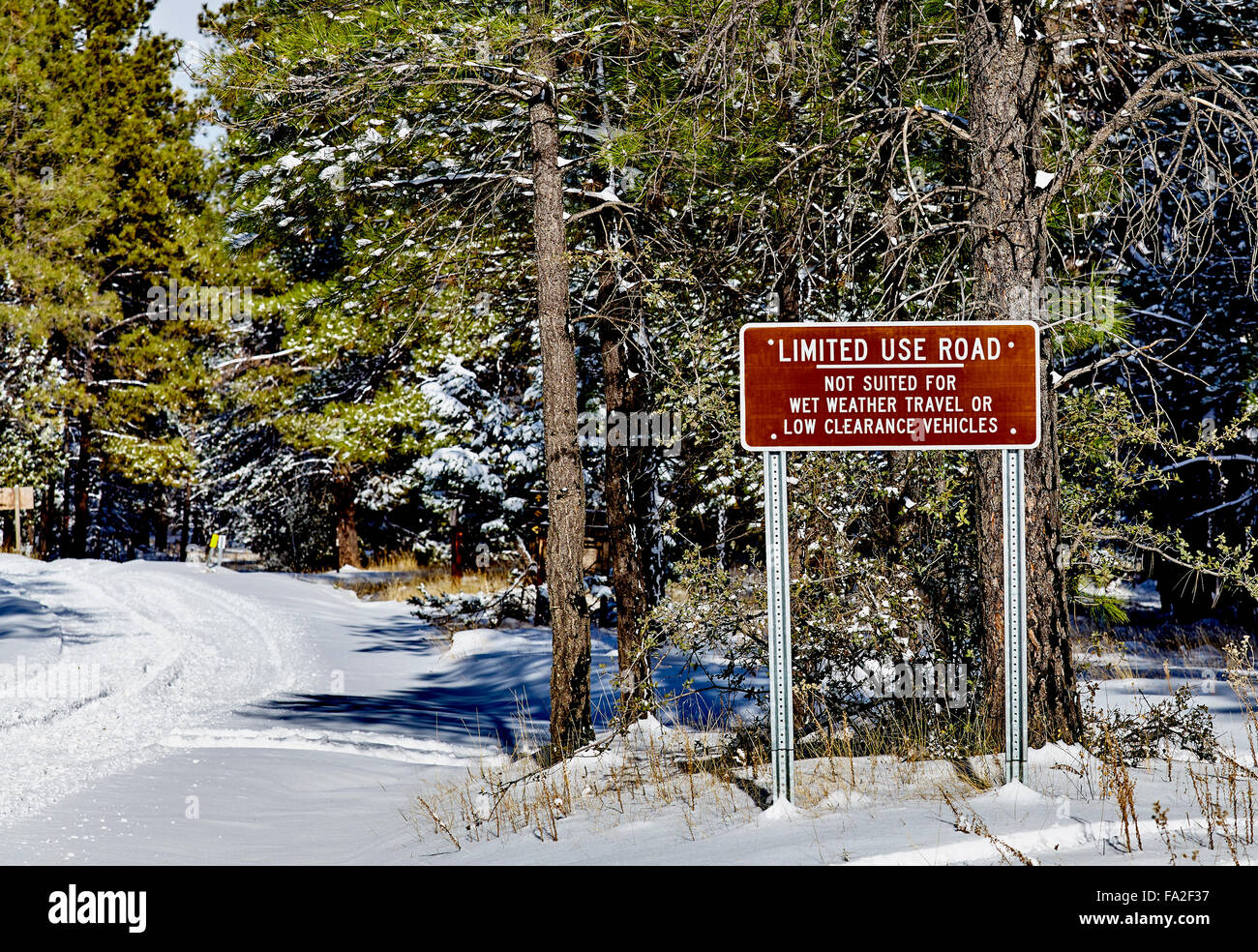 Limited use road sign in snow covered forest Stock Photo - Alamy