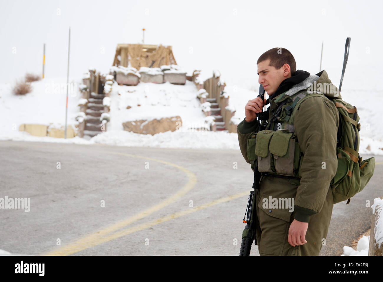 Golan Heights, Syria. 20th Dec, 2015. An Israeli soldier stands guard ...