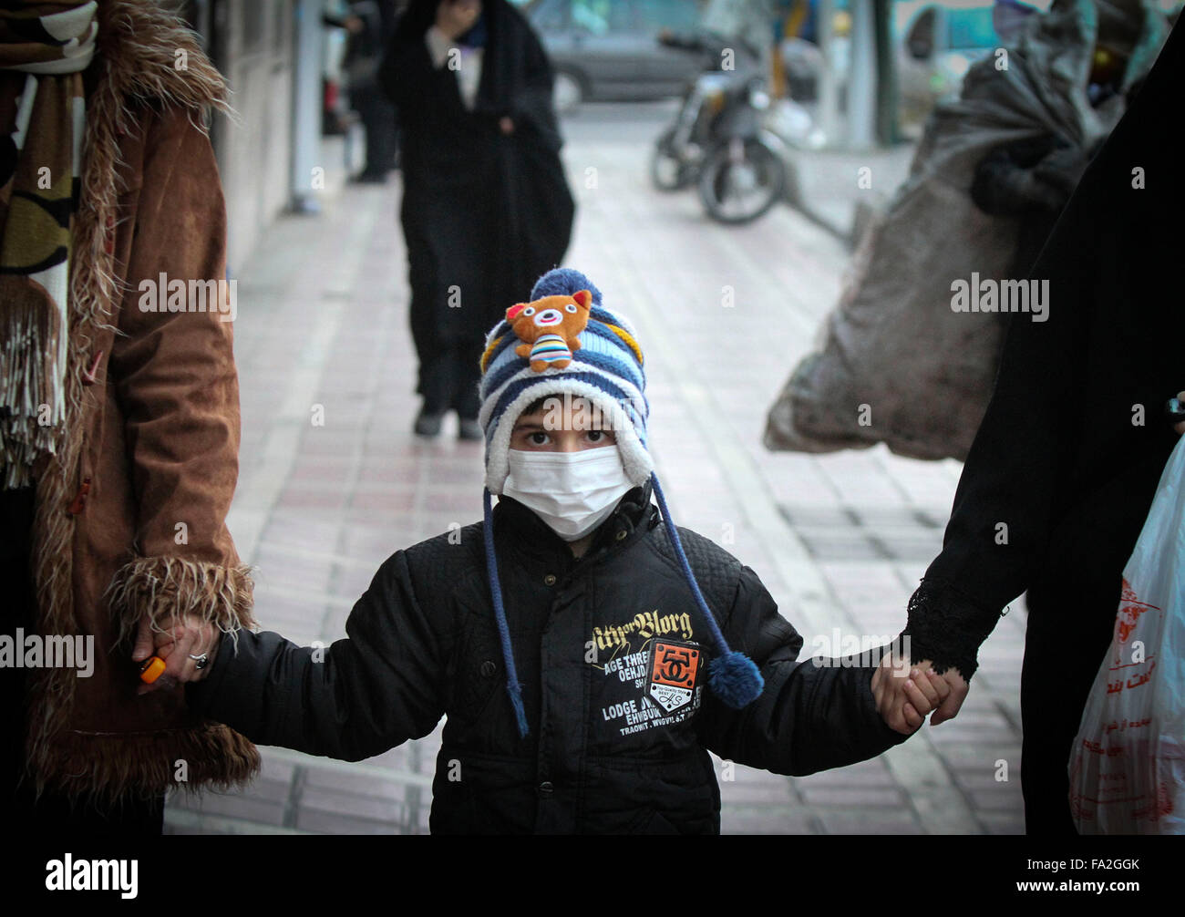 Tehran, Iran. 20th Dec, 2015. An Iranian boy wearing a protective mask ...