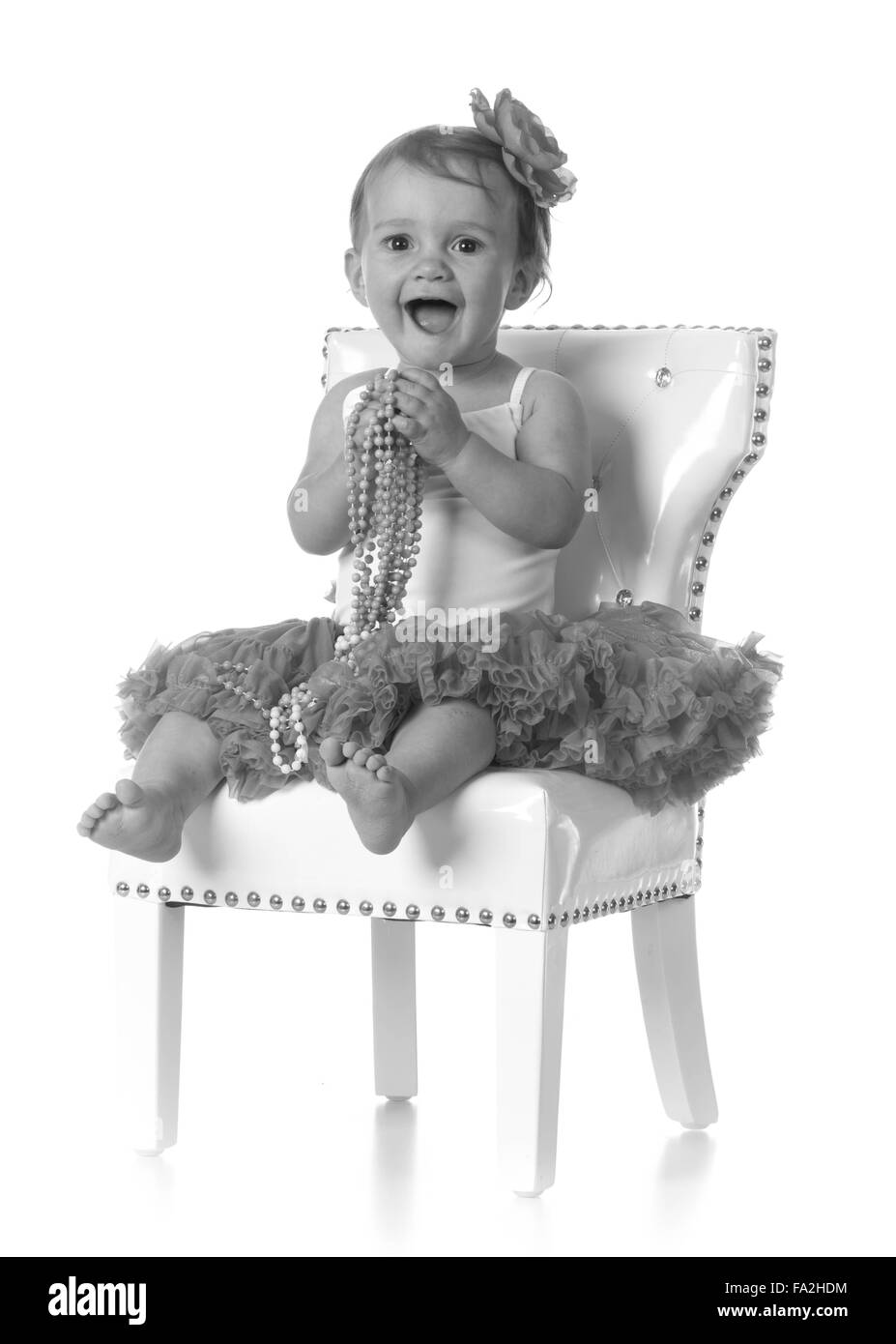 happy one year old girl wearing tutu sitting on a white chair Stock ...