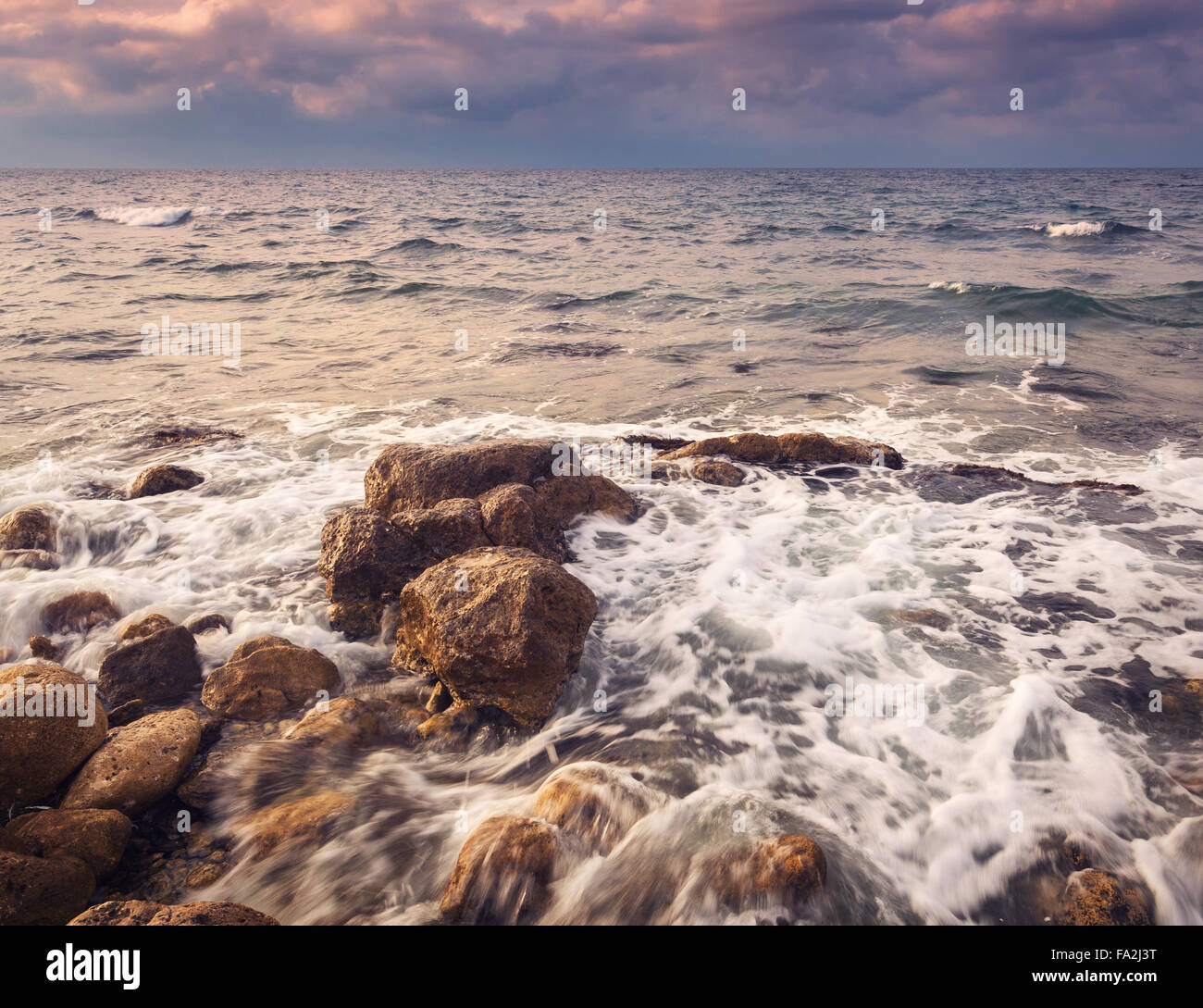 Sea waves with rocks on the beach at sunset. Beatuful landscape Stock ...