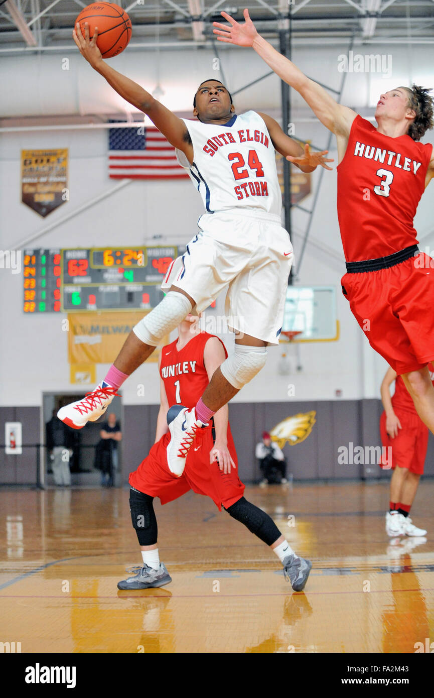 A high school forward leaves the floor and shields the ball from an ...
