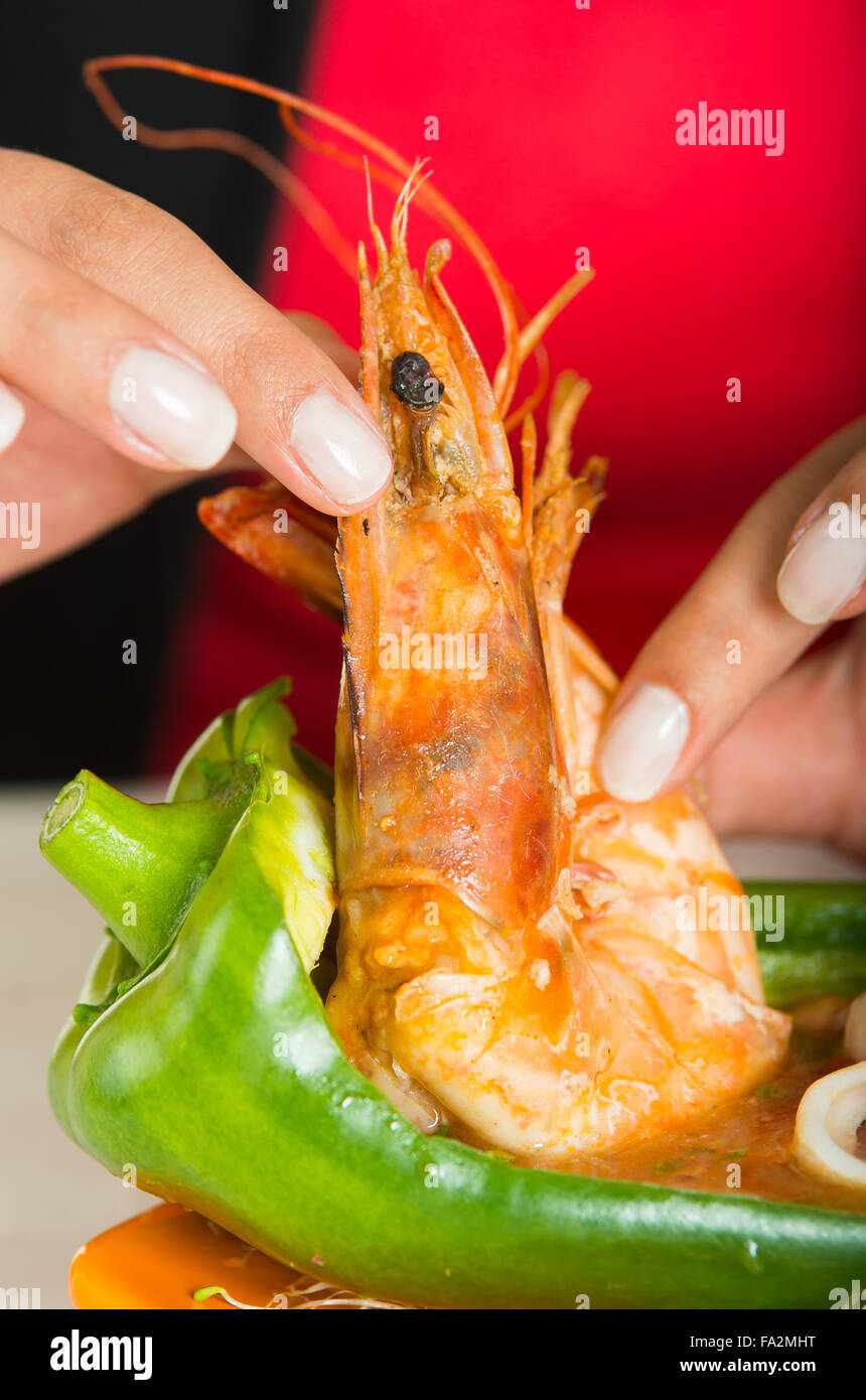 Young woman eating a big delicious shrimp Stock Photo - Alamy