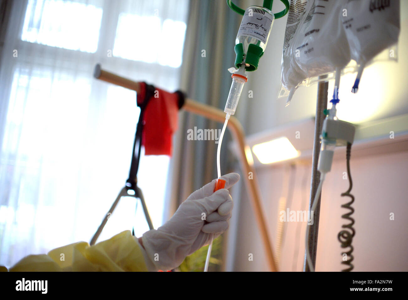 Berlin, Germany. 07th Dec, 2015. Hospital aide Andrea Dede prepares an ...