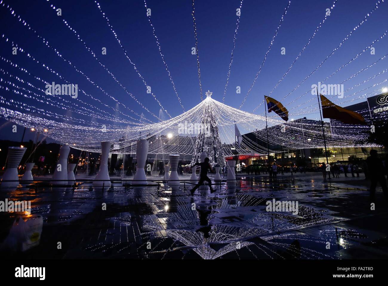 Bogota, Colombia. 20th Dec, 2015. A child runs past a Christmas tree in ...