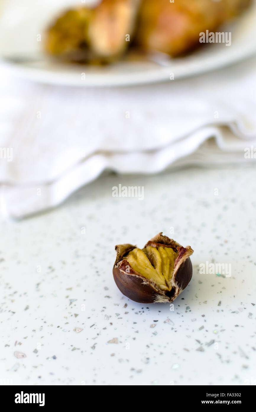 Edible chestnut consist of split coat on table Stock Photo - Alamy