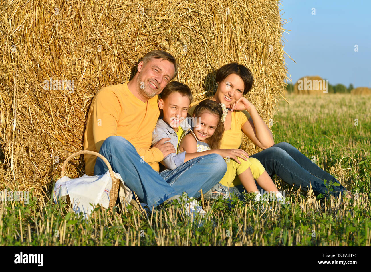 Happy family in wheat field Stock Photo - Alamy