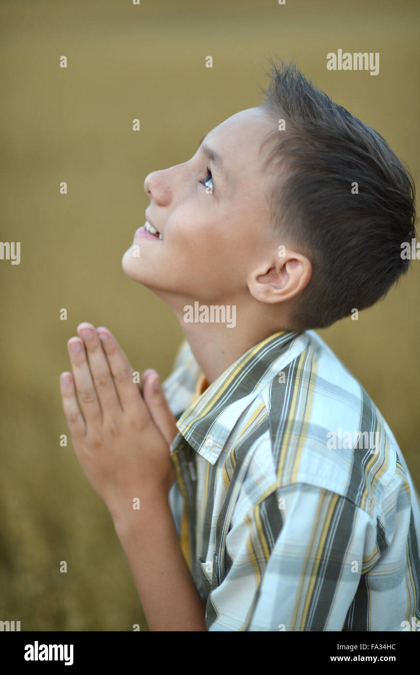 Boy praying outdoors hi-res stock photography and images - Alamy