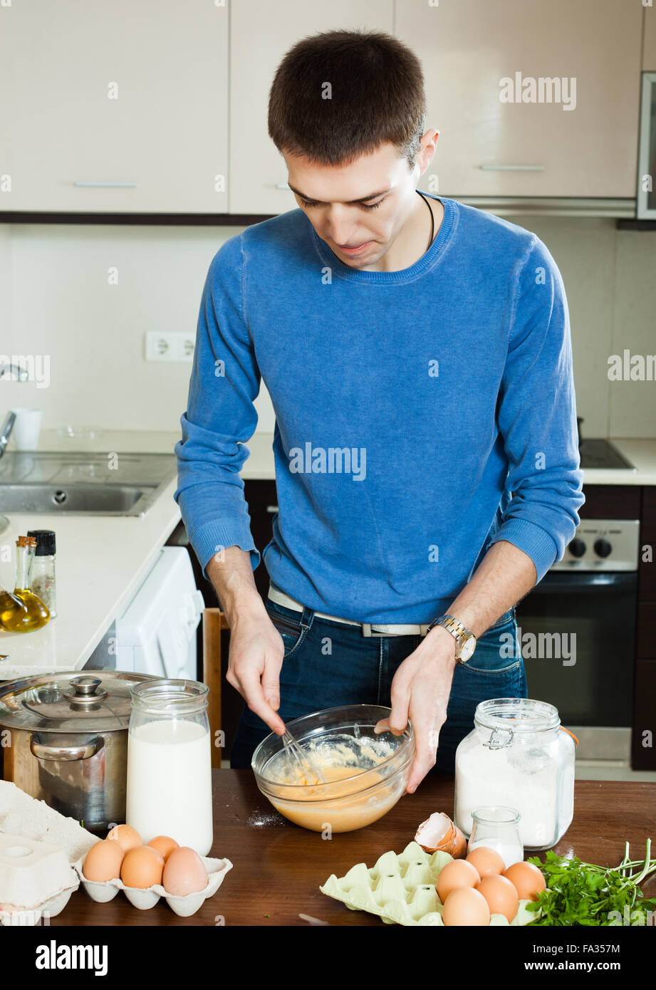 man cooking omelet with flour in the kitchen Stock Photo - Alamy