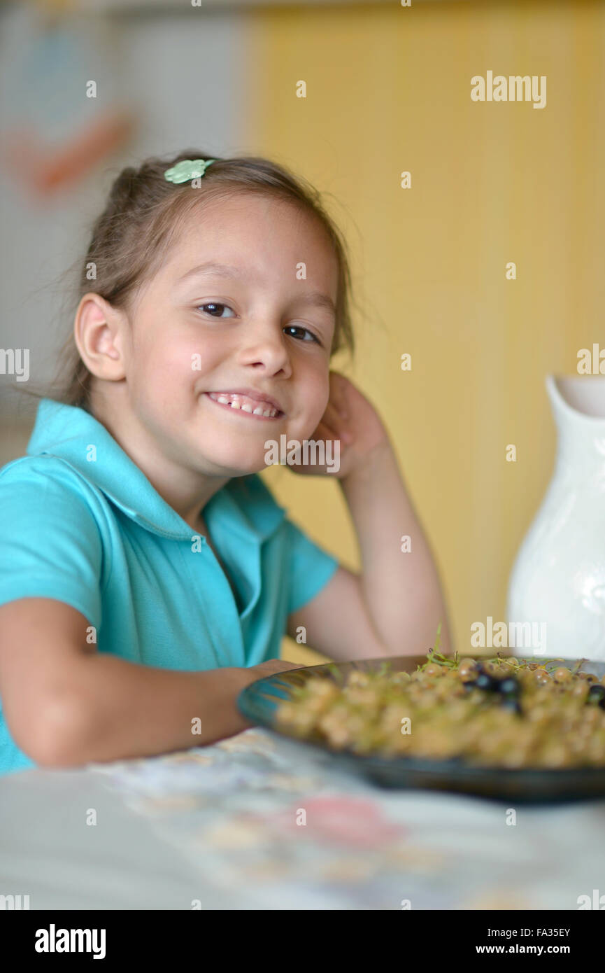 Adorable little girl having breakfast Stock Photo - Alamy