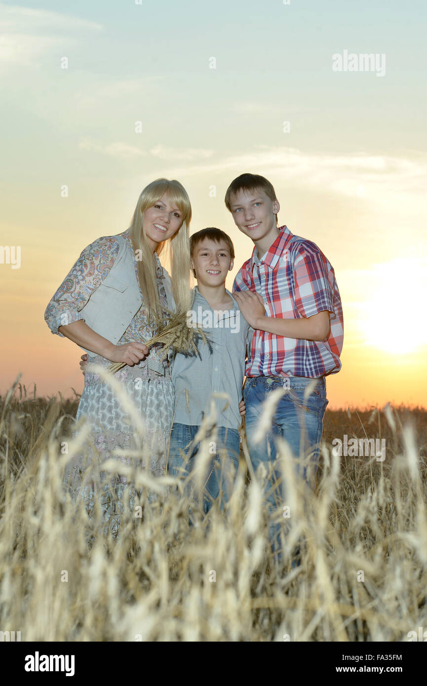 Mom and sons in the field Stock Photo - Alamy
