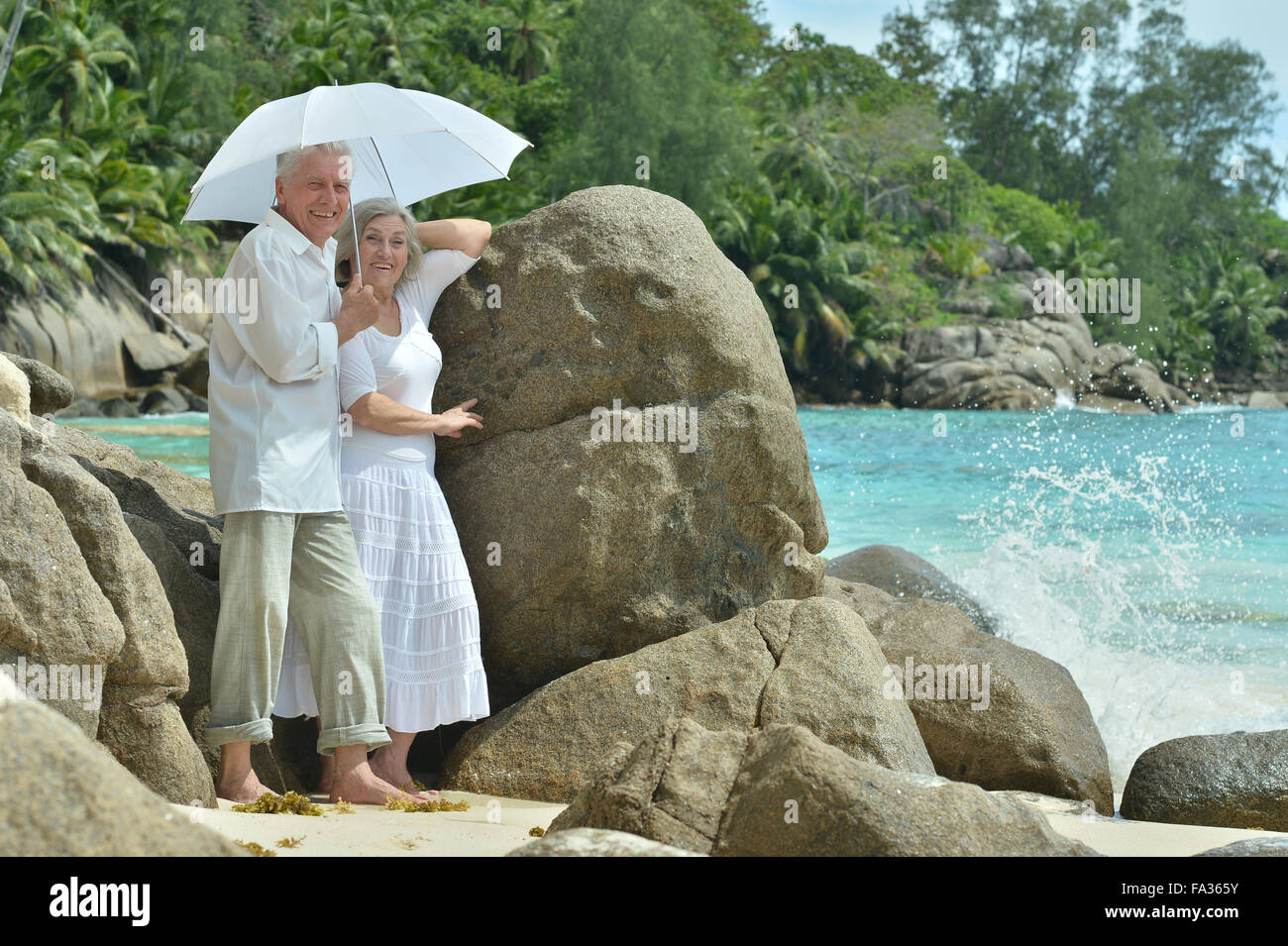 Elderly couple rest at tropical resort Stock Photo - Alamy