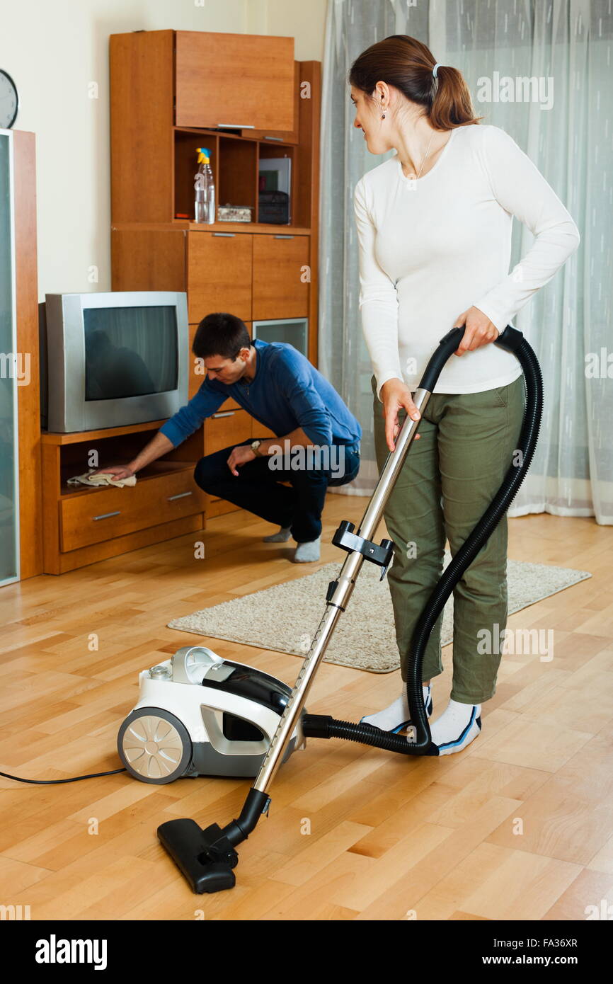 Adult couple doing housework together in home Stock Photo - Alamy