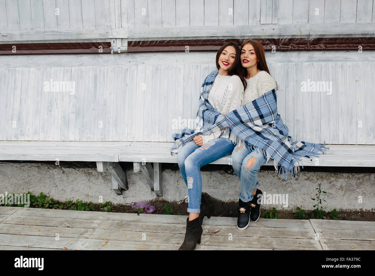 Two girls sit on bench hi-res stock photography and images - Alamy