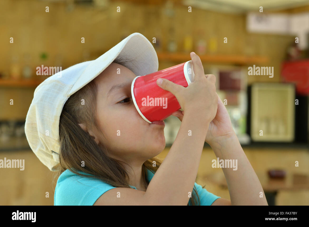 Little girl drink from cup Stock Photo - Alamy