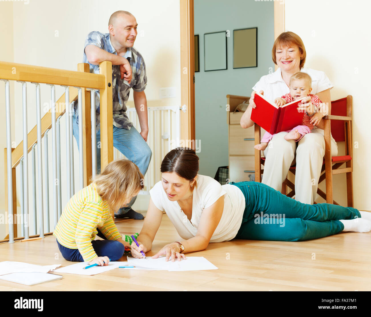 happy three generations family with two children enjoying at home ...